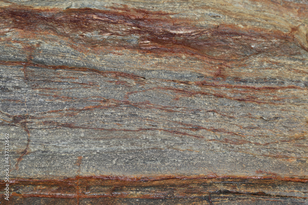 Metamorphic layered sedimentary rock formation with iron deposit top ...