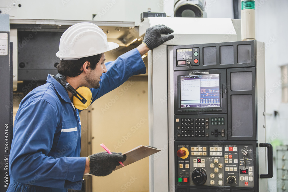 Workers inspecting workpieces from CNC machines. The worker measures ...
