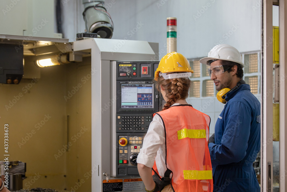 portrait of an industrial man and woman engineer with tablet in a ...