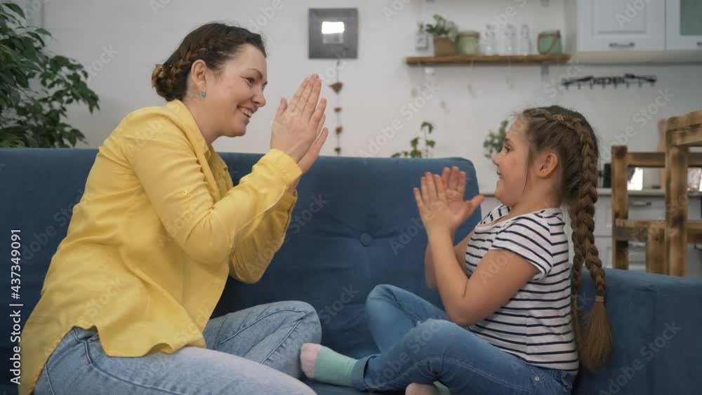 Happy family. Mom and daughter clap their hands. Lockdown coronavirus ...