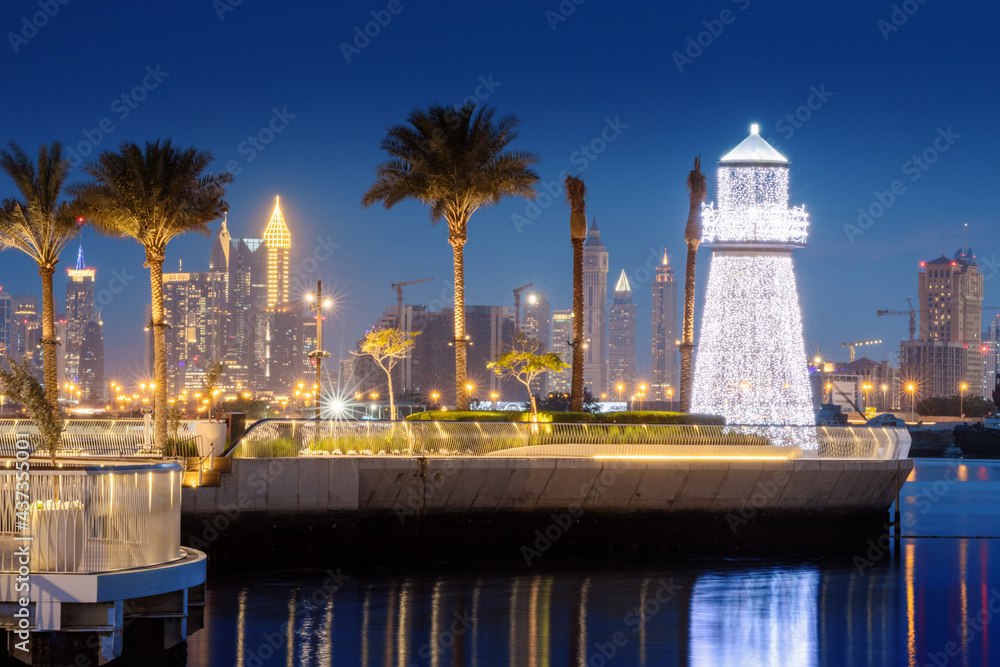 Illuminated decorative lighthouse near the parking lot of yachts and ...