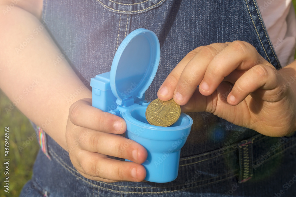 Hands holding a gold coin. Money in the toilet. money in a toilet bowl ...