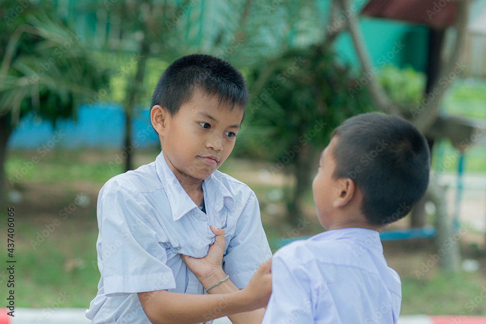 Two Asian schoolboys facing each other getting bullied Children ...