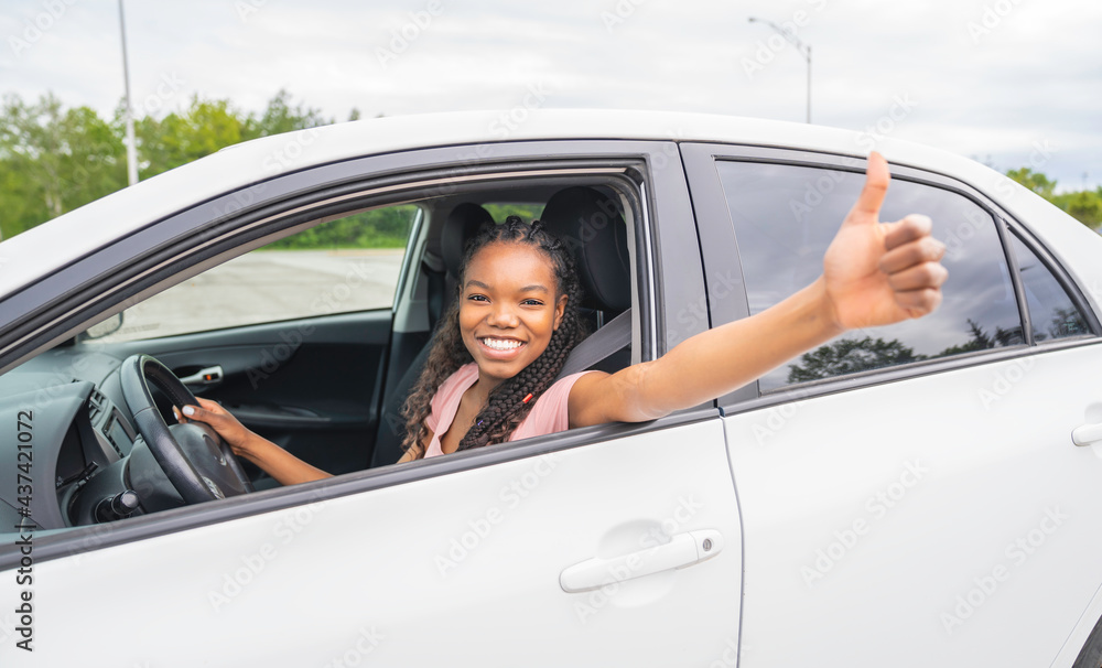 Young black teenage driver seated in her new car Stock Photo | Adobe Stock