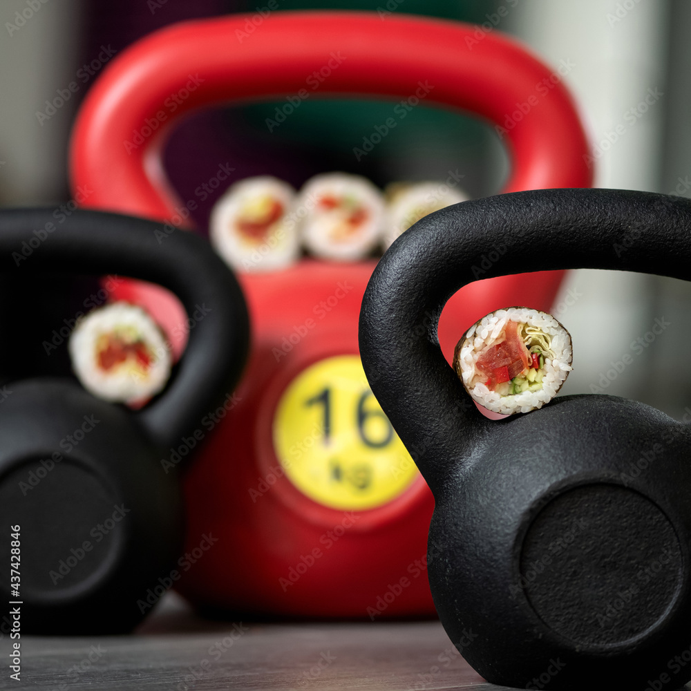 Healthy Oriental food. Sushi rolls and kettlebell weights for strength ...