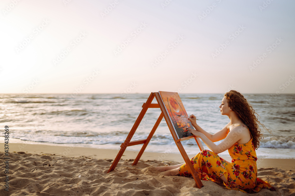 Beautiful woman artist drawing her picture on canvas with oil colors at ...