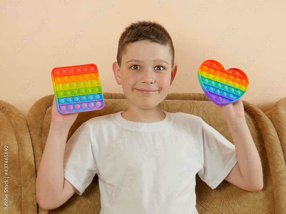 Little boy playing with a modern drink toy. Colorful and vivid toy pop ...