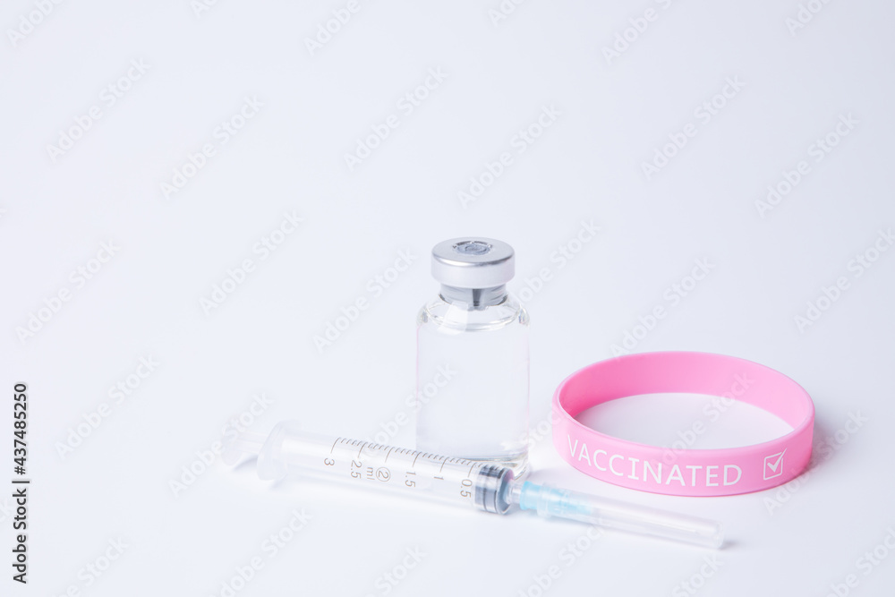vials of medicine/vaccine, syringe and rubber wrist band with ...