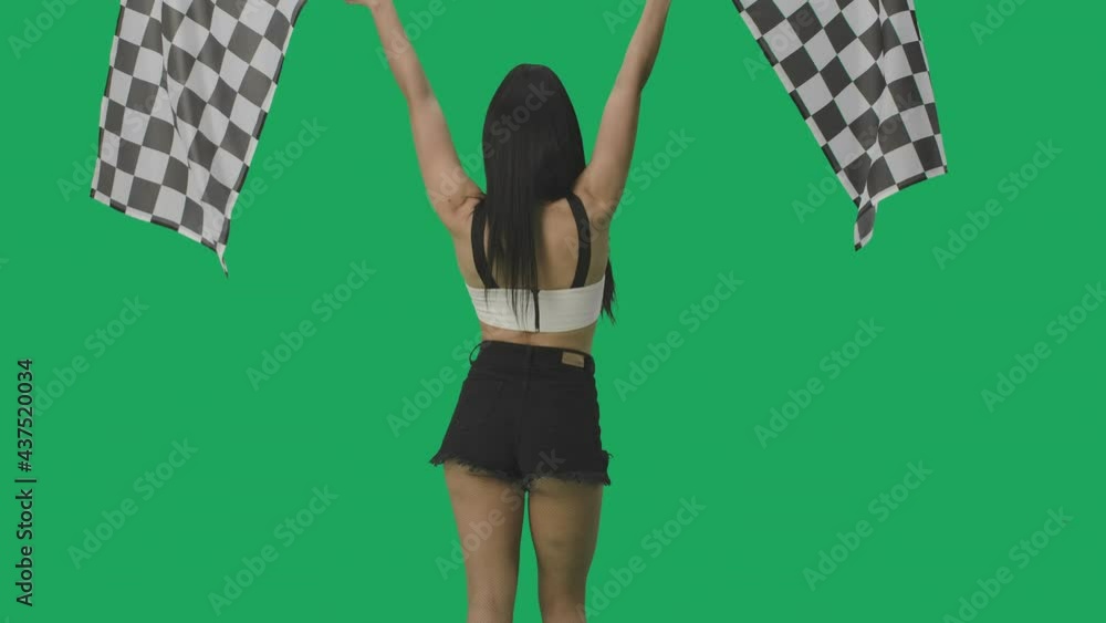 Vidéo Stock Rear view of brunette waving black and white checkered ...