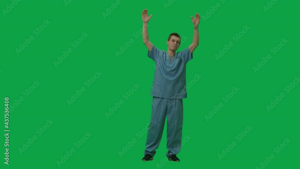 Portrait of young man in a blue suit of a surgeon doctor dancing and ...