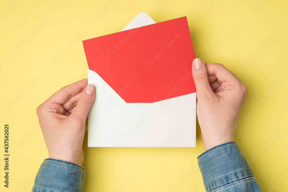 First person top view photo of female hands holding open white envelope ...