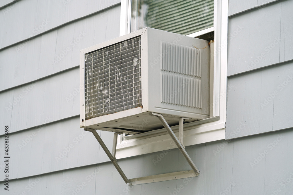 old air conditioner installed on rustic house window Stock Photo ...