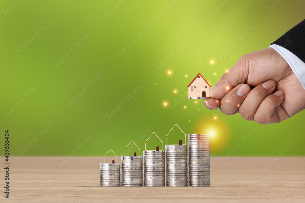 Business property investment with business man hand stacking coin ...