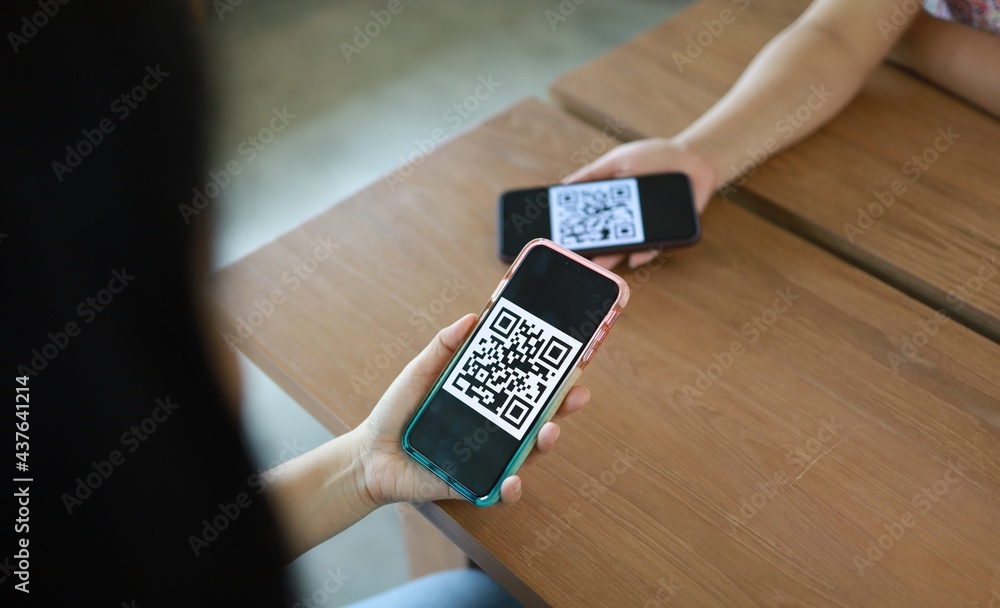 Qr code payment. Woman scanning QR code online shopping cashless ...