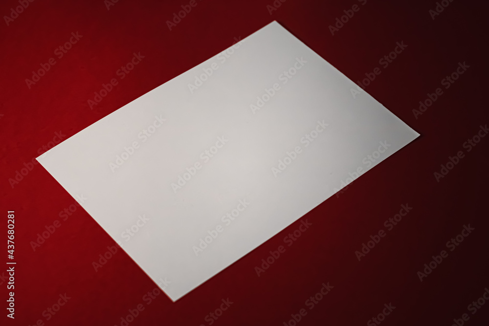 Blank A4 paper, white on red background as office stationery flatlay ...
