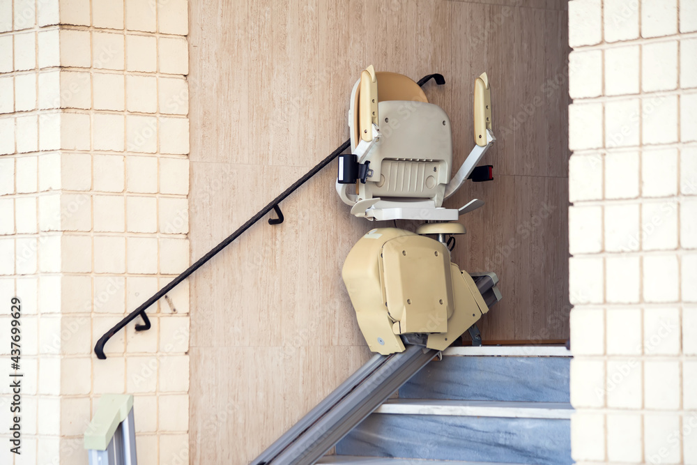 Chair lift for disabled people. Stair elevator Stock Photo | Adobe Stock