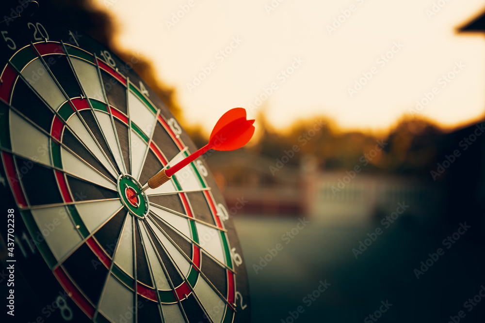 bullseye target or dart board has red dart arrow throw hitting the ...