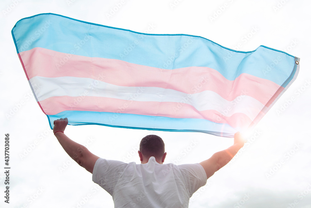 Transgender man holding waving transgender flag, concept picture about ...