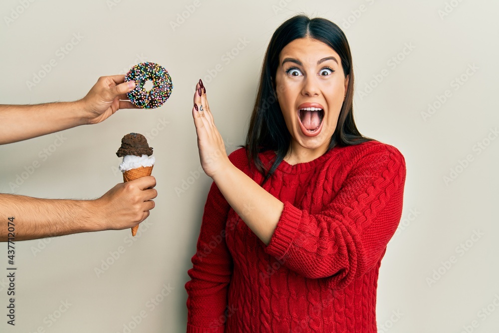 Beautiful brunette woman saying no to sweets on a healthy diet ...