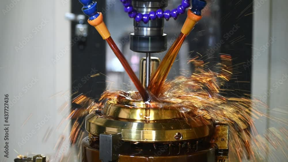 The CNC milling machine cutting the shell mold parts with oil coolant ...