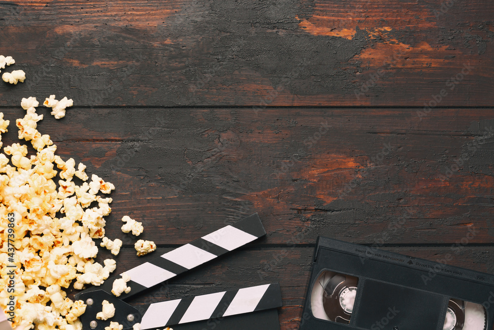 Cinema concept. Popcorn in a box, video cassette VHS and movie clapper ...