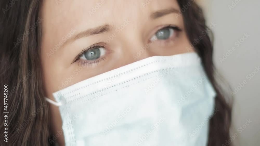 Vidéo Stock Woman with sad blue eyes in protective face mask, sadness ...