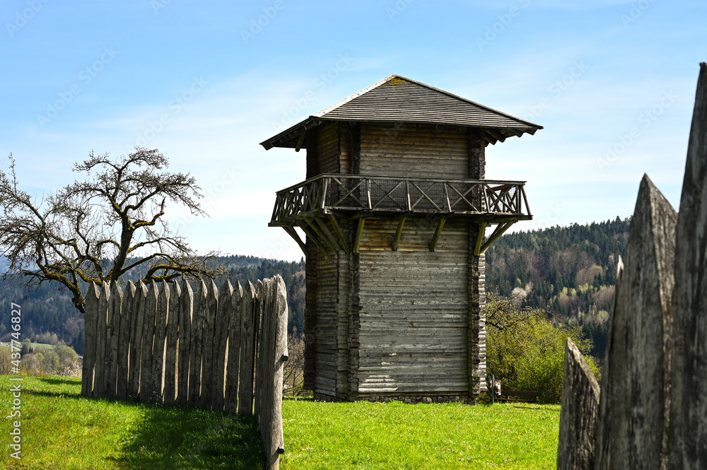 A reconstructed wooden Roman watchtower and a wooden border fence under ...
