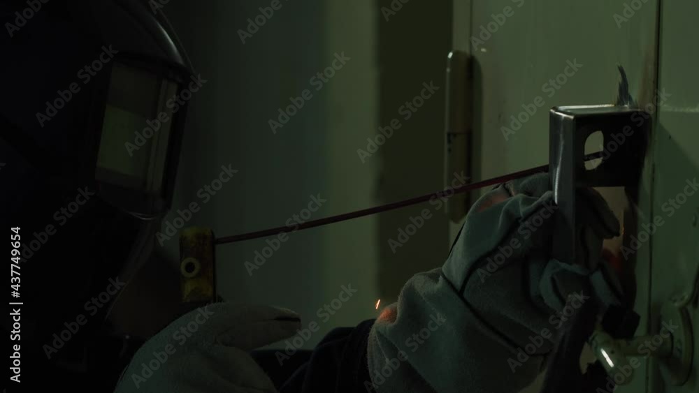 The welder man working in a factory and sparks flying. Processing of ...