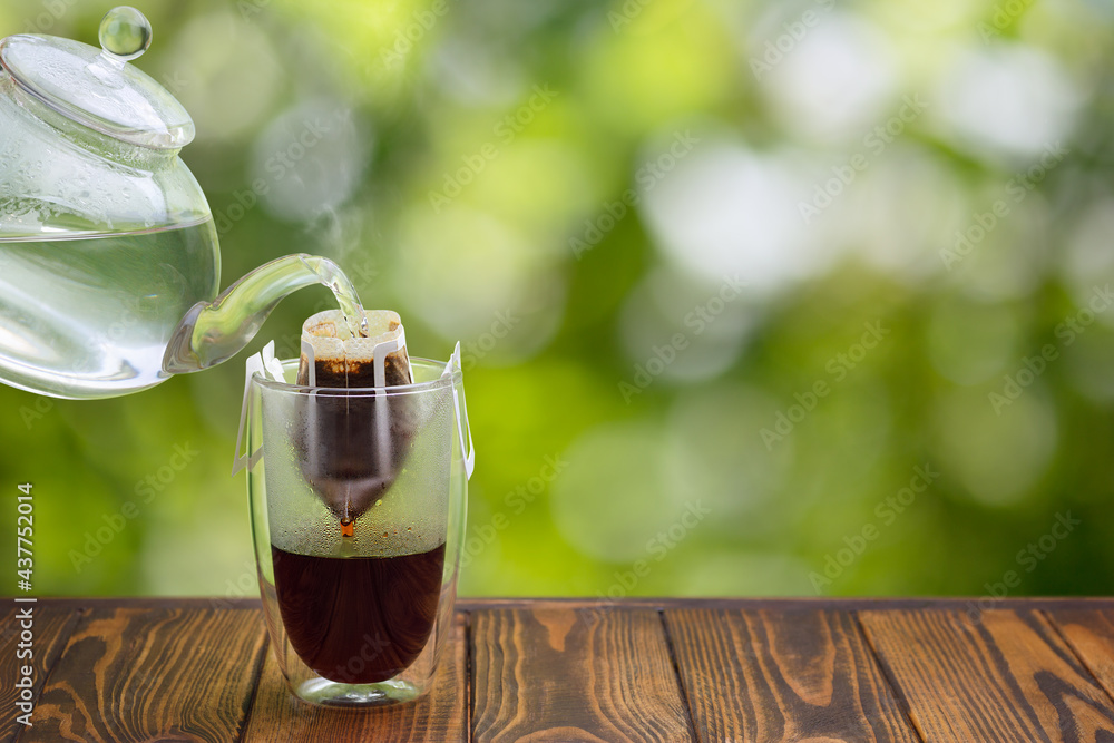 hand drip coffee in glass on wooden table Stock Photo | Adobe Stock