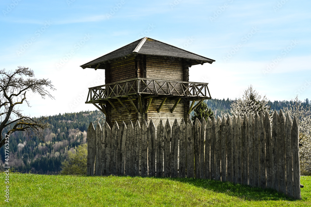 A reconstructed wooden Roman watchtower and a wooden border fence under ...