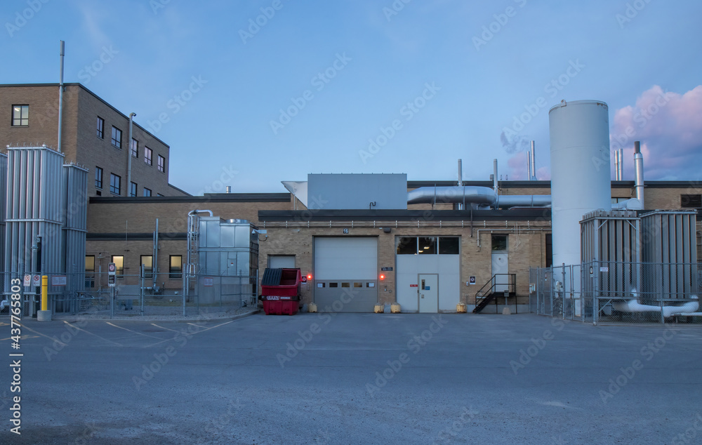 Exterior of low rise brick laboratory building at dusk showing liquid ...