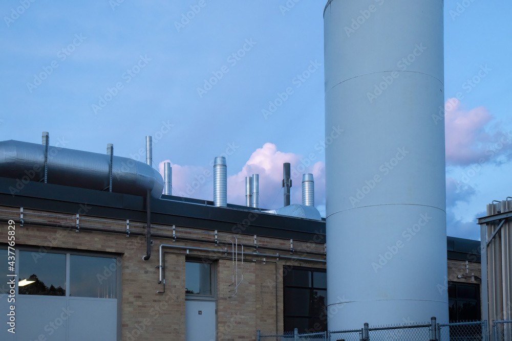 Liquid nitrogen storage tank next to brick laboratory building, exhaust ...