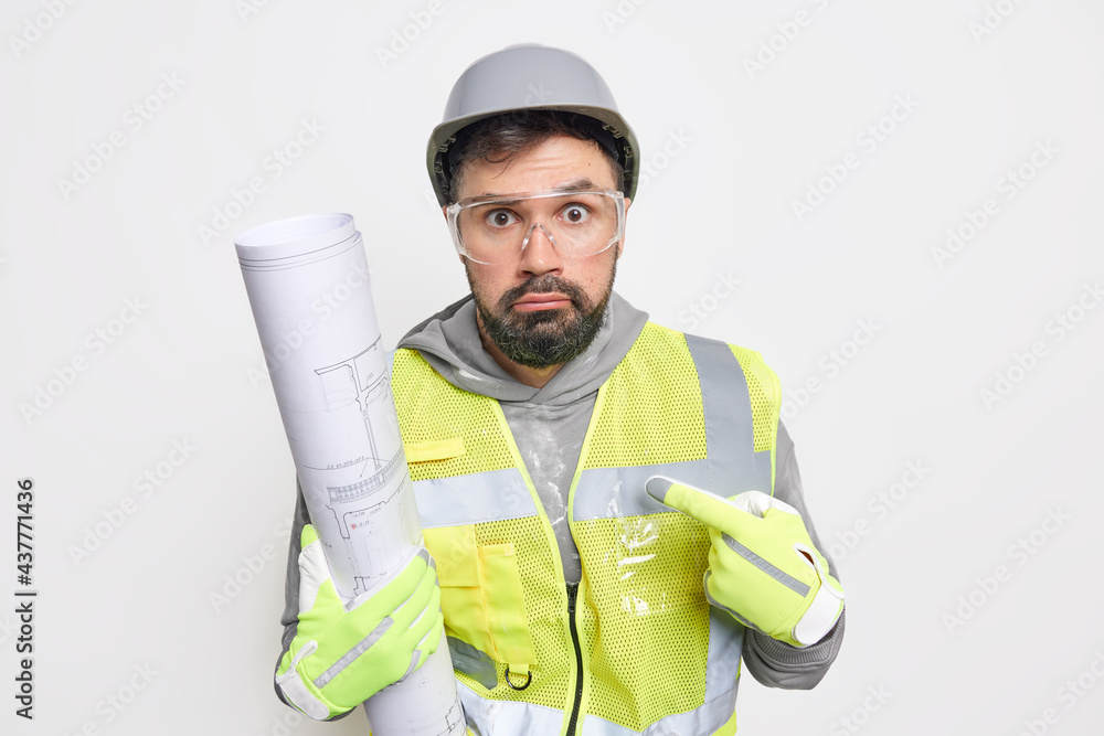 Puzzled man engineer holds building blueprint points at himself asks ...