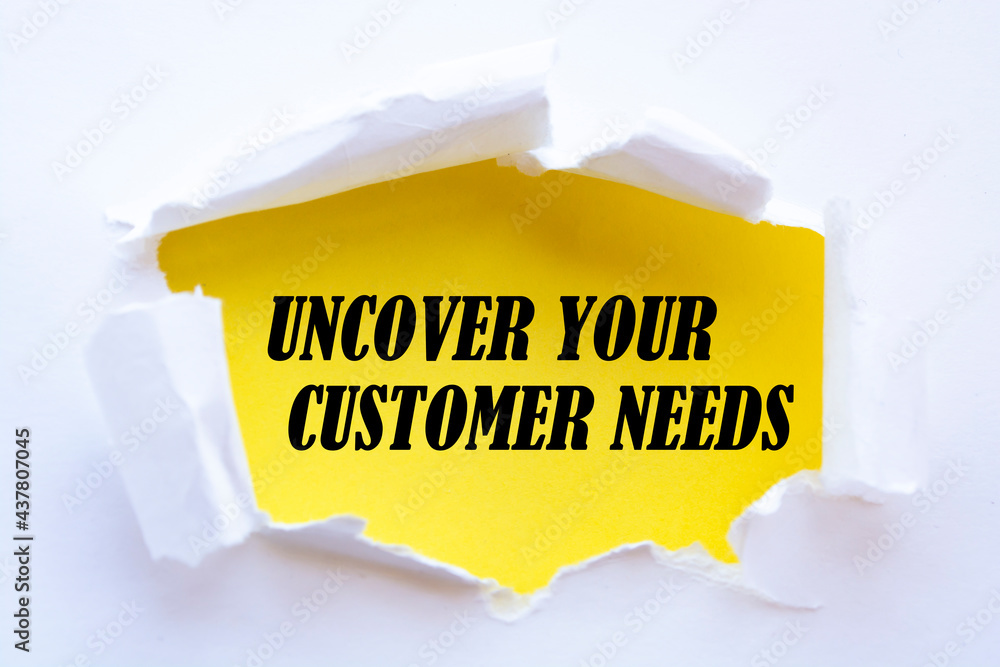 Text Uncover Your Customer Needs appearing behind torn paper. Concept ...