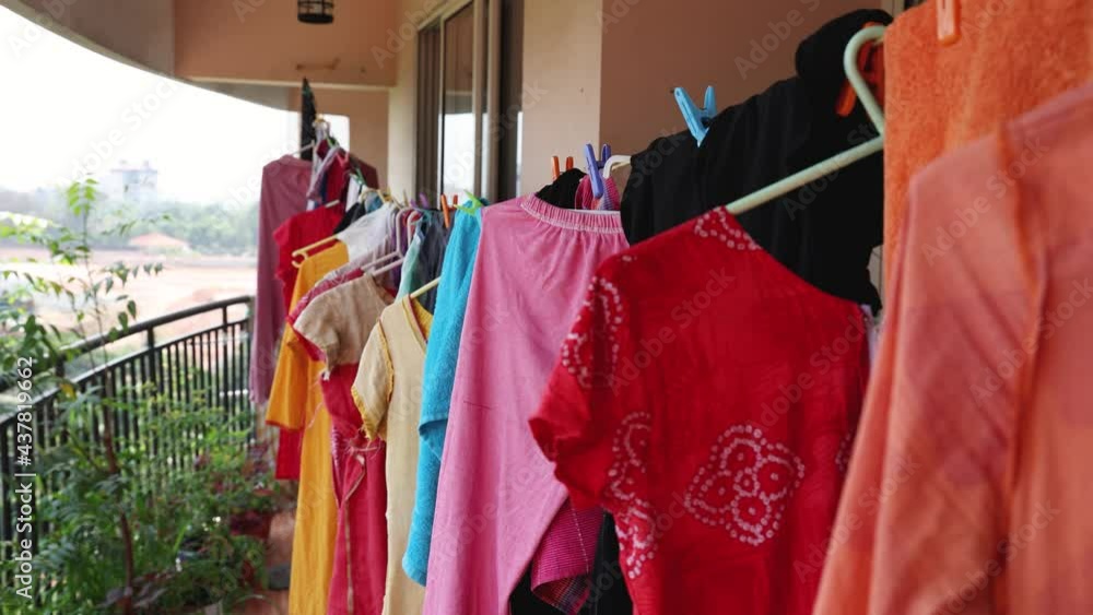 Hanging clothes on washing line for drying in balcony of apartment ...
