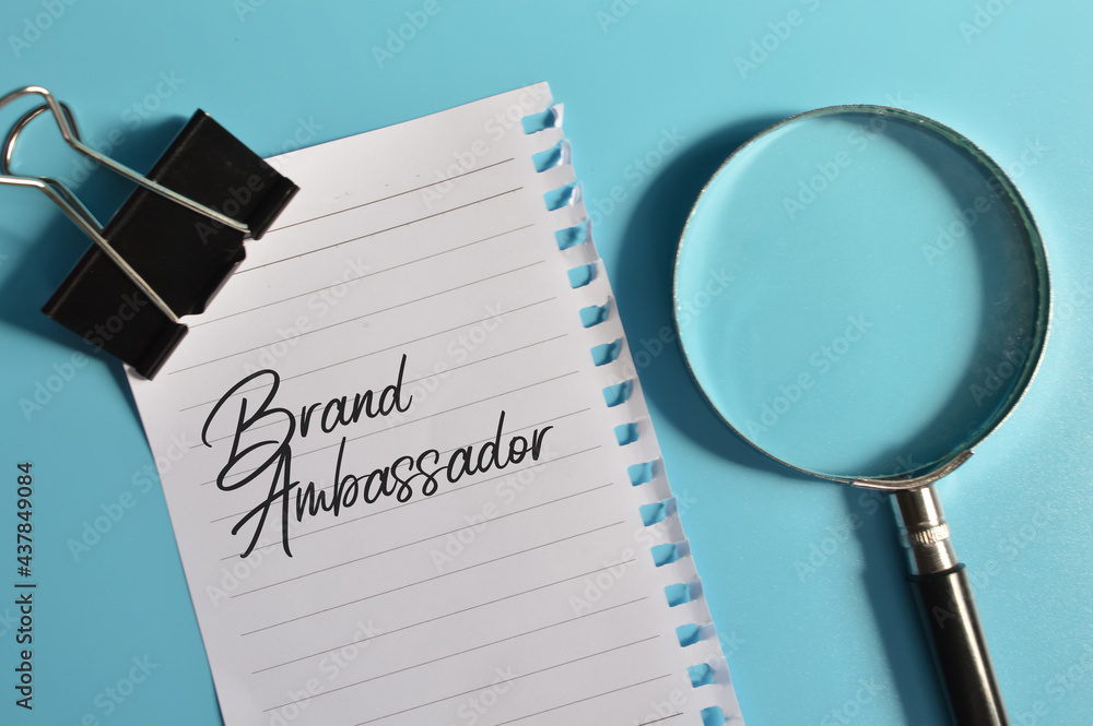Poster Top view of magnifying glass and white paper written with BRAND ...