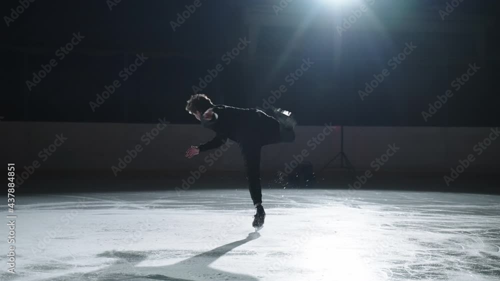 Professional male figure skater performs a complex figure skating ...