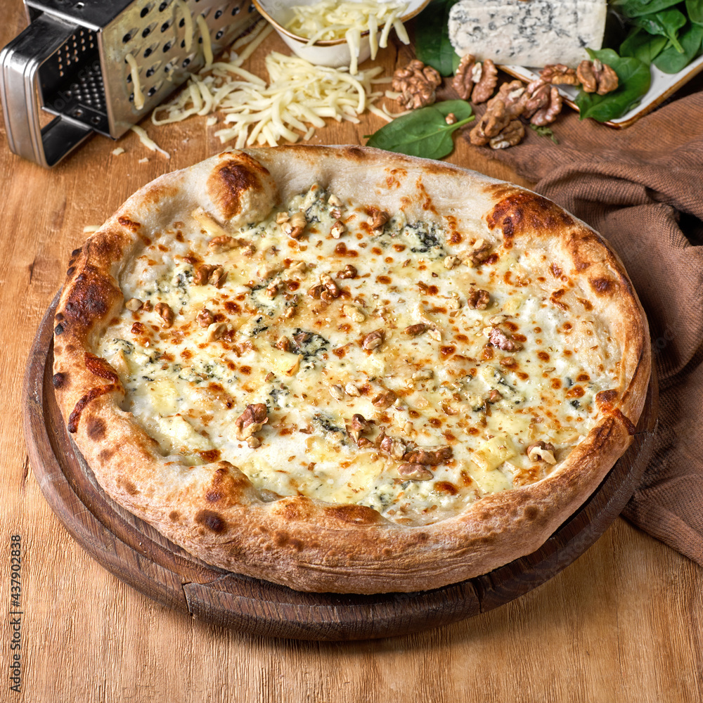 Four Cheese Pizza or Quattro Formaggi Pizza topped with tomato sauce, mozzarella, gorgonzola ...