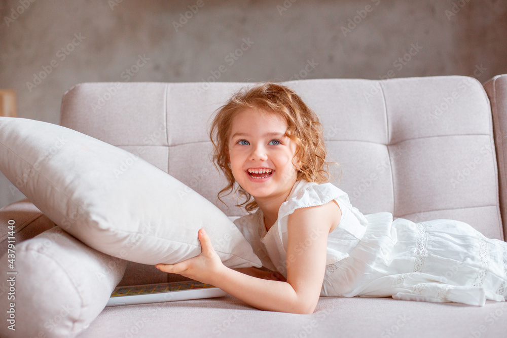 little girl lying on the couch Stock Photo | Adobe Stock