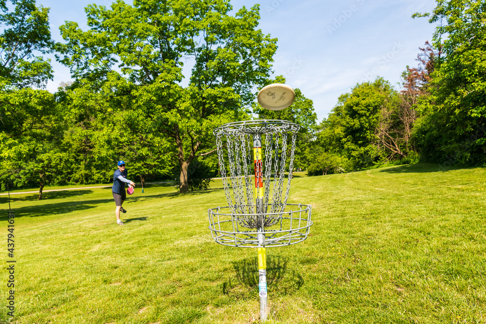 Disc golf is a flying disc sport in which players throw a disc at a ...