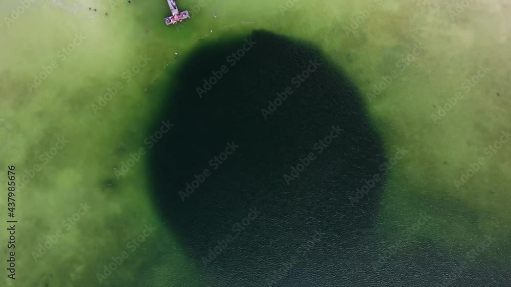A large lake with a deep cenote inside. Aerial view of Kaan Luum lagoon ...