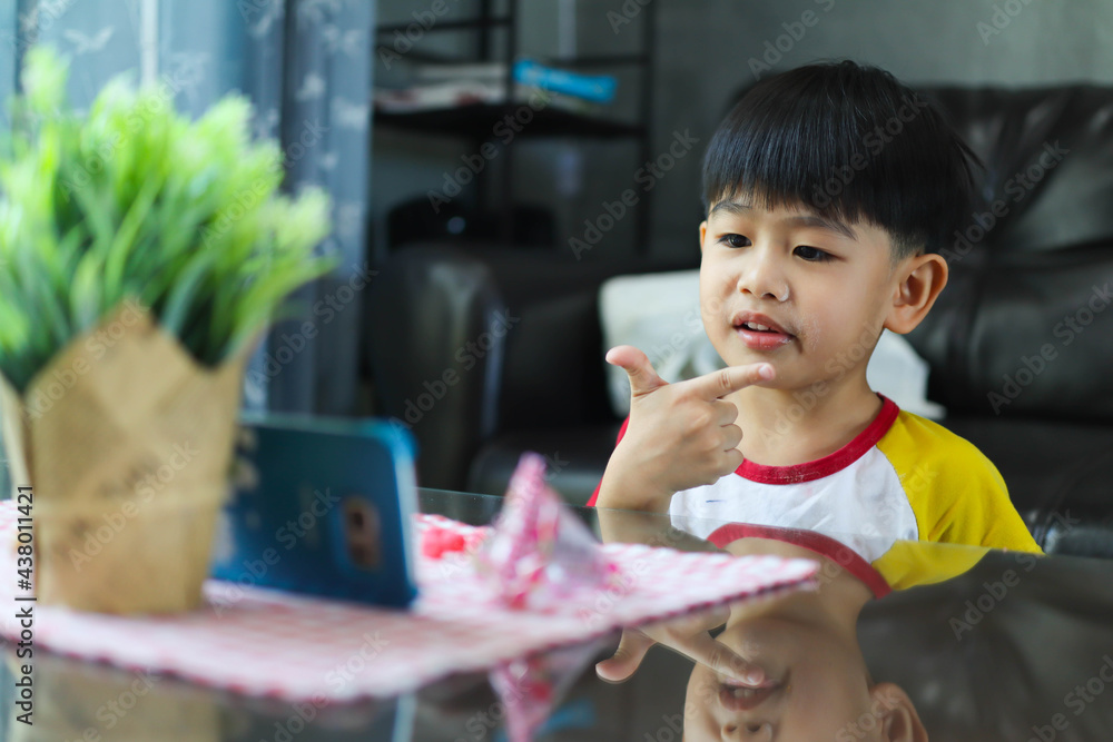 Cute Asian child learning class study online with video call from ...