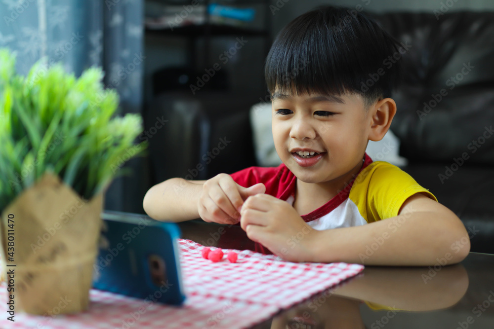 Cute Asian child learning class study online with video call from ...