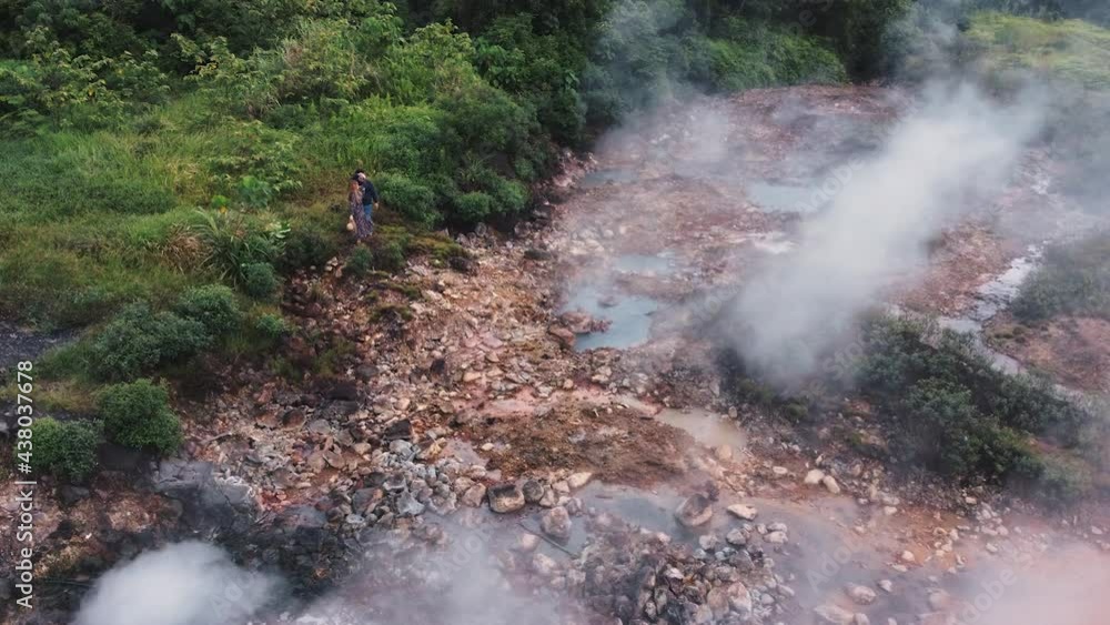 Beauty in nature. Couple enjoying the scene of steam rising out of the ...
