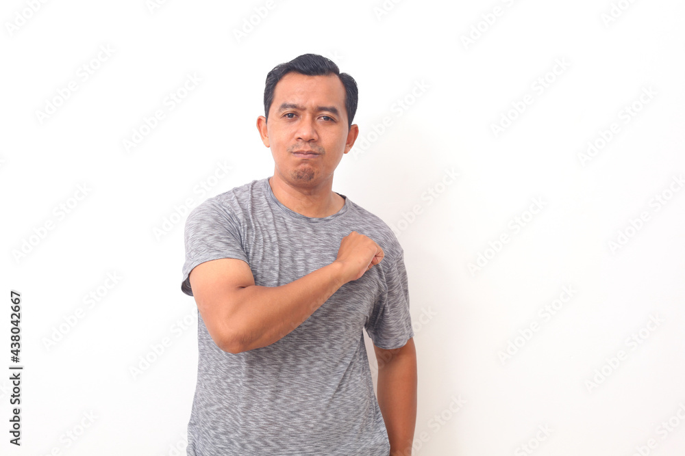 Asian man bang his fist on his chest as a sign of confidence. Isolated ...