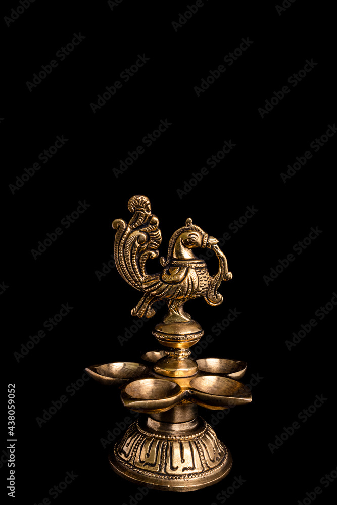 Indian traditional bronze oil lamp in the form of a bird on a black ...