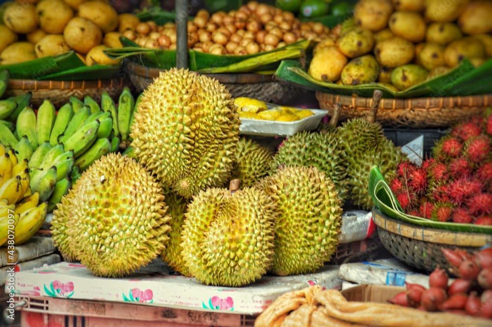Fresh durians, rambutans and other fruits sold in the local market in ...