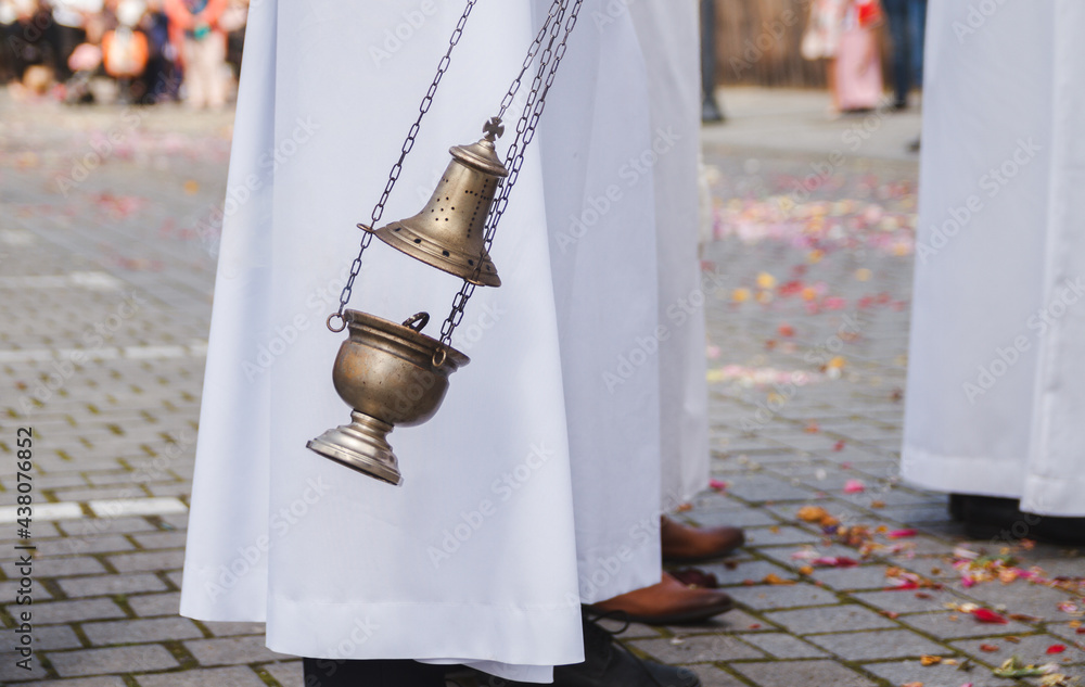 Priest holding Catholic thurible during the Feast of Corpus Christi ...