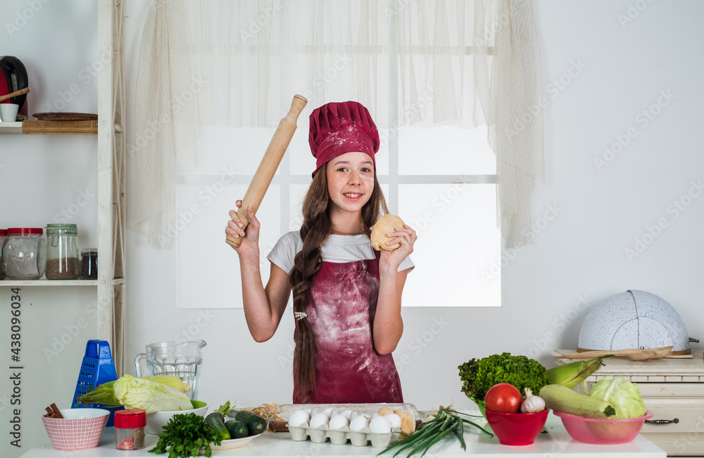 Helpful tools. teen girl chef wearing uniform. child study how to cook ...