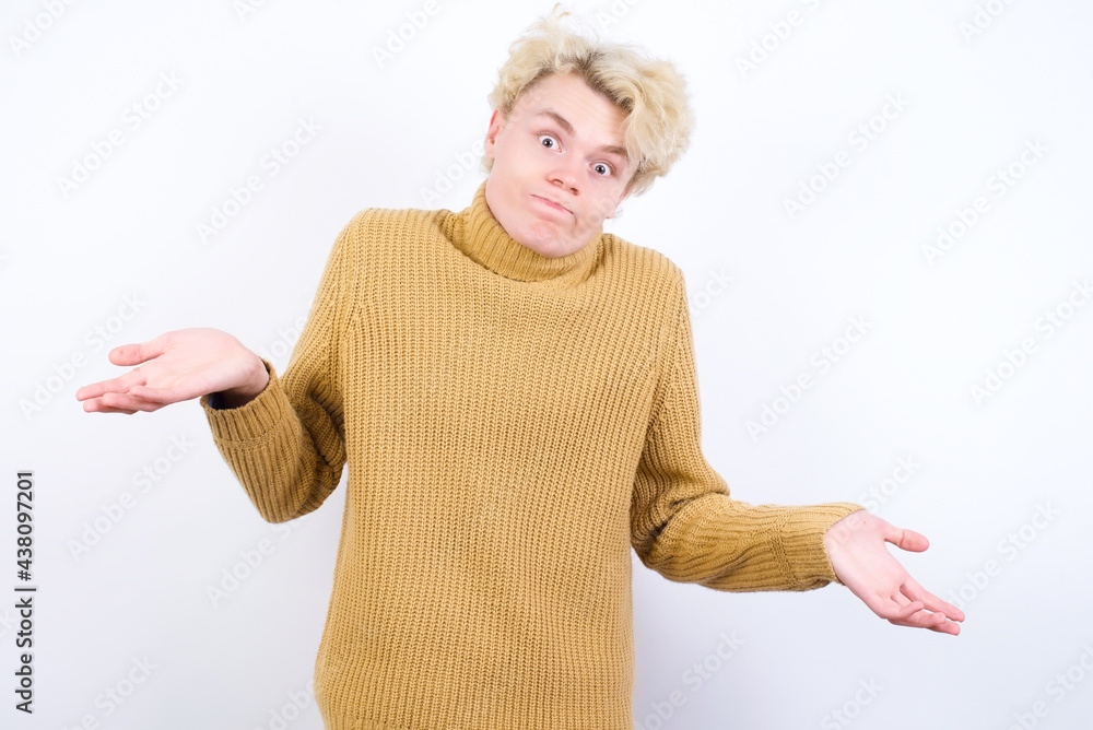 Puzzled and clueless Young handsome Caucasian blond man standing ...